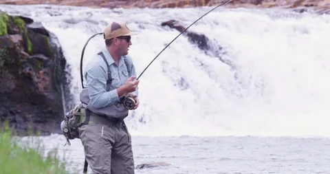 A fisherman fights a fish in front of an... | Stock Video | Pond5