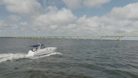 A fishing boat glides across the water n... | Stock Video | Pond5