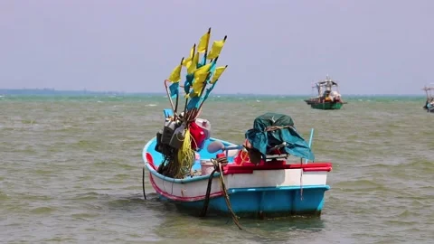 A fishing boat is rocking on the waves i... | Stock Video | Pond5