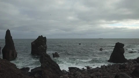 Fishing ship sailing behind jagged sea s... | Stock Video | Pond5