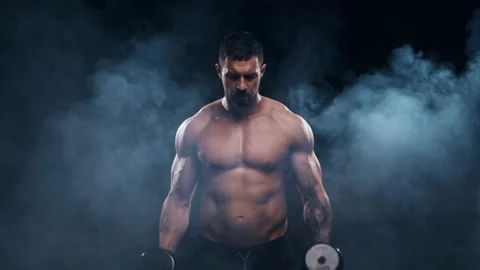 Fit and sporty bodybuilder over black ba... | Stock Video | Pond5