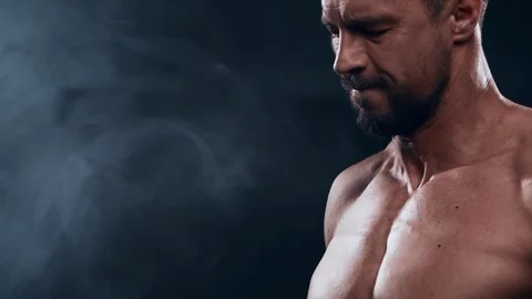 Fit and sporty bodybuilder over black ba... | Stock Video | Pond5