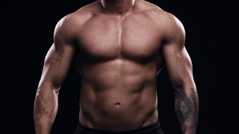 Fit and sporty bodybuilder over black ba... | Stock Video | Pond5