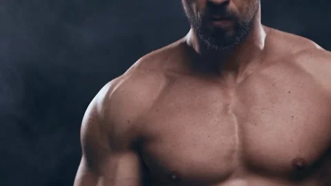 Fit and sporty bodybuilder over black ba... | Stock Video | Pond5