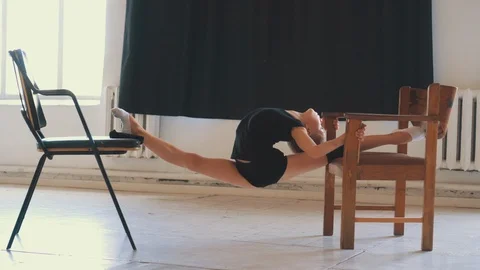 Fit gymnast doing straddle split between... | Stock Video | Pond5