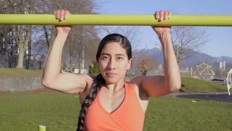 Fit lean woman doing pullups on bar at p... | Stock Video | Pond5