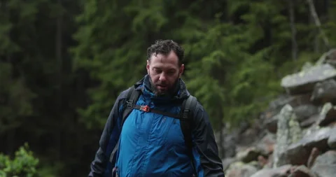 A fit young man is walking alone on a ro... | Stock Video | Pond5