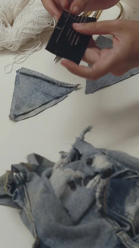 Fitting two triangles denim cut-outs to ... | Stock Video | Pond5