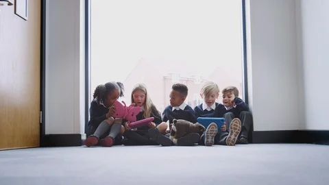 Five primary school kids sitting on the ... | Stock Video | Pond5