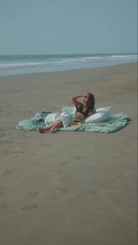 Fixed Shot of Woman Lying in Bed on Beac... | Stock Video | Pond5