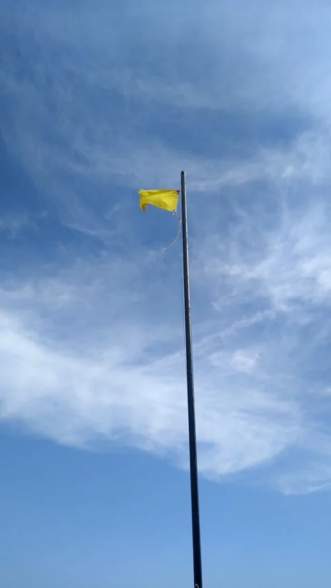 A flag in the wind shows the strength of... | Stock Video | Pond5