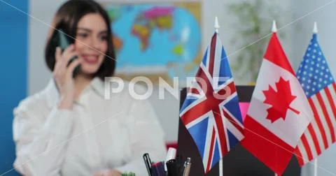 Flags of different countries on a table in a travel agency, in the ...