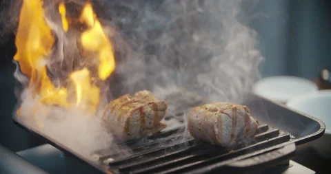 Flambe Fire Searing Pork on Cast Iron Gr... | Stock Video | Pond5