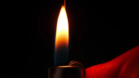 The flame of a lighter on a dark backgro... | Stock Video | Pond5