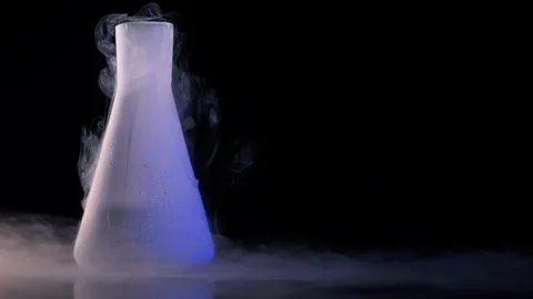 Flask with liquid nitrogen on black back... | Stock Video | Pond5