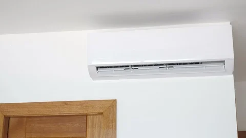 Flat air conditioner on white wall in ro... | Stock Video | Pond5