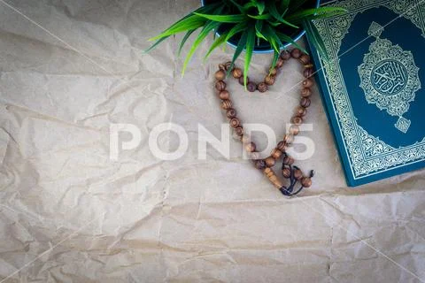 Flat lay Holy Quran with arabic calligraphy meaning of Al Quran and ...