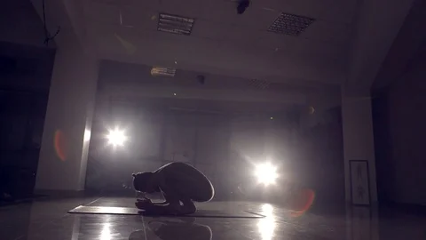 Flexible man stands on his hands in a gy... | Stock Video | Pond5