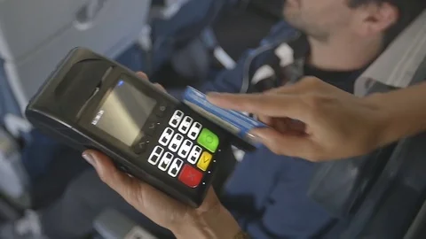 Flight attendant sliding credit card | Stock Video | Pond5