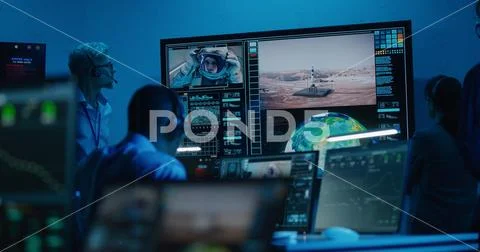Flight control operators monitor space mission on computers in command ...