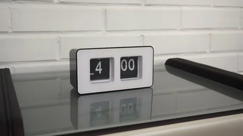 Flip clock mechanism. 4:00 PM. White bri... | Stock Video | Pond5