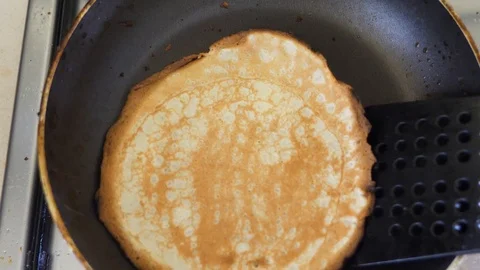 Flipping burnt pancake in pan | Stock Video | Pond5