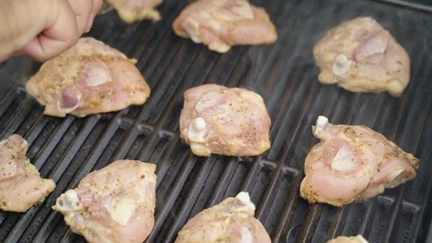 Flipping chicken breasts on a barbecue r... | Stock Video | Pond5