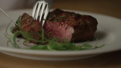 Flipping a Slice of Steak on a Garnished... | Stock Video | Pond5