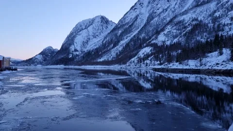 floating ice flakes on water with mounta... | Stock Video | Pond5