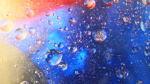 Floating oil bubbles on water, Blue, gol... | Stock Video | Pond5