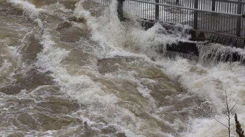 Flood waters rushing over dam during sev... | Stock Video | Pond5