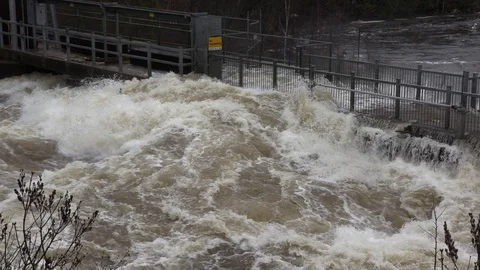 Flood waters rushing over dam during sev... | Stock Video | Pond5