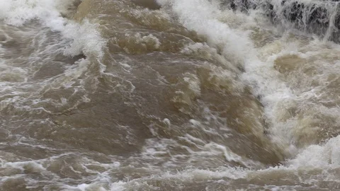 Flood waters rushing over dam during sev... | Stock Video | Pond5