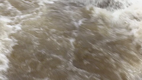 Flood waters rushing over dam during sev... | Stock Video | Pond5