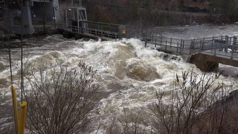 Flood waters rushing over dam during sev... | Stock Video | Pond5