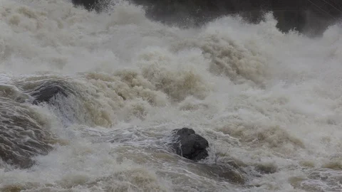 Flood waters rushing over dam during sev... | Stock Video | Pond5