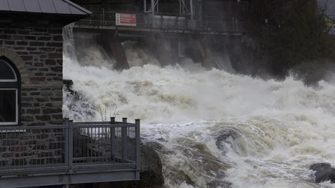 Flood waters rushing over dam during sev... | Stock Video | Pond5