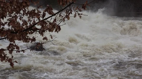 Flood waters rushing over dam during sev... | Stock Video | Pond5