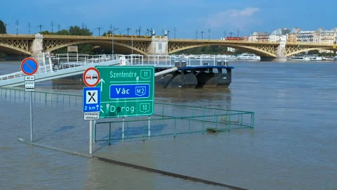 Floodwaters submerging road signs alongs... | Stock Video | Pond5