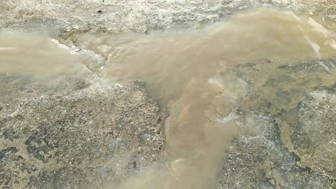 flow of a dirty melted puddle in spring | Stock Video | Pond5