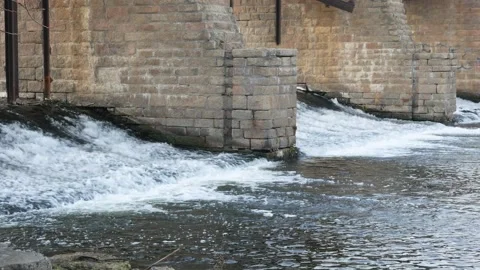The flow of a fast river at the dam. Riv... | Stock Video | Pond5