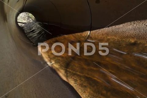 Flowing water inside concrete culvert , Finland Stock Image #195850641