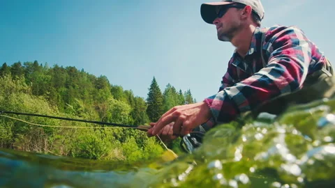 Fly fishing for shy fish. Angler crouche... | Stock Video | Pond5