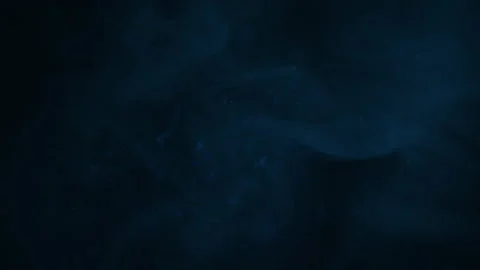 Fly particles and blue smoke on dark gru... | Stock Video | Pond5