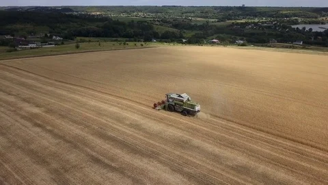 Flying around combine work in the wheat ... | Stock Video | Pond5
