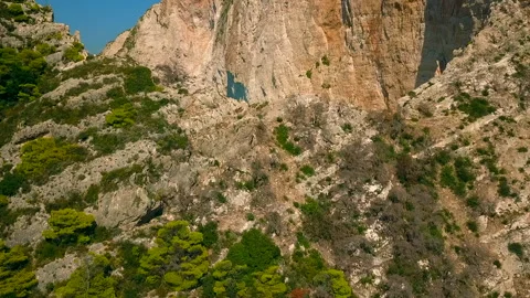 Flying over a steep cliff, revealing the... | Stock Video | Pond5