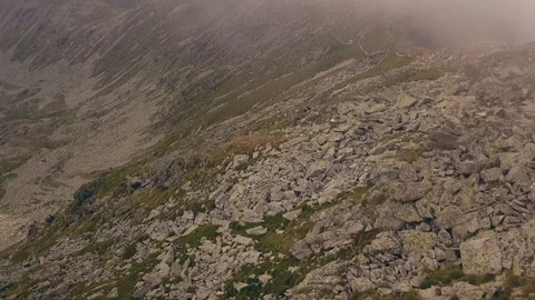 Flying over the top of rock piles that a... | Stock Video | Pond5