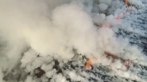 Flying over wildfire and plumes of smoke... | Stock Video | Pond5