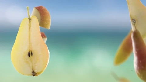 Flying of Pear and Slices in Beach Backg... | Stock Video | Pond5