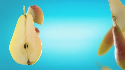 Flying of Pear and Slices in Ice Blue Ba... | Stock Video | Pond5